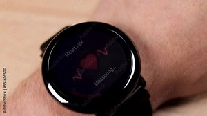 Man checking heart rate, measuring pulse with smart watch, fitness bracelet on wrist