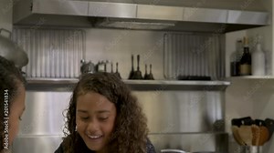 Two girls baking cookies together.