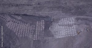 Aerial view of blasting holes coal mining area, open-pit mine, quarrying. Drone shooting preparing for blasting open cast mine mining of coal, overall plan.