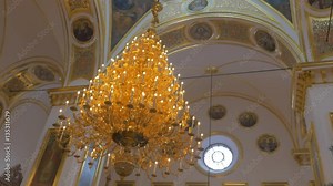 a Golden Looking Chandelier and Nice Iconostasis in an Old Orthodox Cathedral With High Dome Ceiling and a Lot of Marvelous Saint Images in it