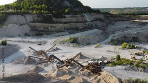 Aerial view opencast mining quarry. Mining trucks and Conveyor system in a limestone quarry.