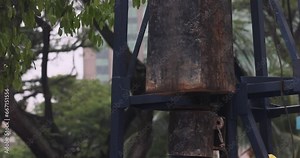 Pile driving machine driving piles into ground site. Modern hydraulic lifting mechanisms.