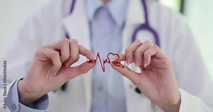 Female doctor displays heart-shaped brooch with heartbeat cardiogram line. Elegant symbol of woman commitment to field of cardiology in hospital