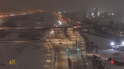 Flashing street lights cutting through winter darkness