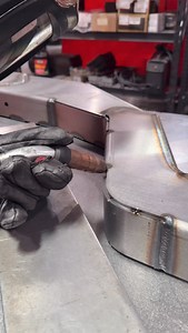 Hailey welding up the bottom side of this rear frame rail for our Squarebody Backhalf kit. It requires flawless technique to keep the weld uniform and consistent as she moves along the bend of the frame rail. Our Backhalf kits differ from our standard rear Dropmember kits in a few different ways including longer frame rails and a narrowed suspension footprint allowing for wider wheels and tires. They can also accomplish a longbed to shortbed conversion. They do come pre-assembled on a pallet mak