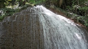 clip-1093341991-water-stream-over-calcareous-rock-sediment-formation