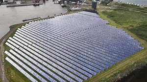 Photovoltaics installed in open spaces along the coastline. Solar energy installation situated next to harbor of Hvide Sande for town's energy needs, heating demands through solar thermal plant.