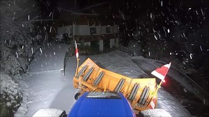 Snowplow in Action: Clearing Winter Paths at Night