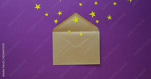 Craft envelope and stars on a purple background top view. 4K stop motion animation