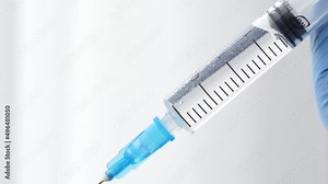 Close Up of injection liquid being in syringe. Medication drug needle syringe drug, flu shot vaccine vial dose hypodermic injection treatment disease prevention immunization.