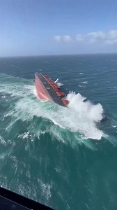 Captured from a Coast Guard surveillance flight, this footage shows the final moments of a massive container vessel caught in a violent storm. The ship, loaded with hundreds of heavy shipping containers, began to list dangerously as it was hammered by 40-foot waves. Without warning, the center of gravity shifted, causing the entire vessel to roll. The colorful cargo spilled like toy blocks into the churning abyss before the hull itself vanished beneath the whitecaps. This video is created with A