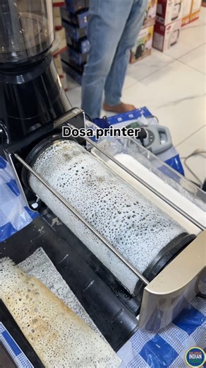 thegreatindianfoodie on Instagram: "Automatic Dosa Printer Machine of Bangalore, future meets dosa! 🤖🫓 Watch perfect dosas roll out with zero skill, zero guesswork, just crispy edges and golden goodness every time. 😍 Tech + taste = next level breakfast vibes! Follow for more quirky, drool worthy food tech reels! (automatic dosa printer, Bangalore food innovation, dosa machine, street food tech, Indian breakfast, food tech, foodie reels, food vlogger, desi food, innovative cooking)"