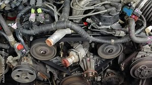 A torn apart Nissan Frontier engine as the engine is being turned over