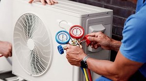Skilled technician conducting commercial HVAC maintenance service with professionalism. Expert electrician inspecting air conditioner installation for safety.