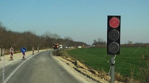 Red stoplight, traffic light signalization for regulation during road maintenance