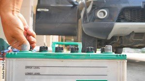 Close up of a man to check car battery before drive