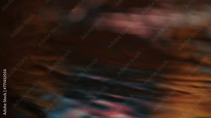 Water surface with waves from raindrops and multi-colored lighting. Close-up shot of a flooded street in the city at night with the reflection of the light of lanterns.