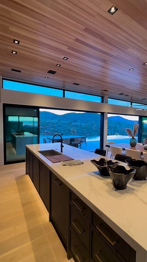 Morning views at our #netzero project. Hard to beat that view of the desert sunrise from this kitchen and these multi-sliders. | AFT Construction | Facebook