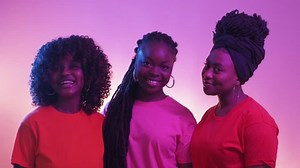 Female friends. Happy model. Neon light people. Smiling casual black women posing on blue purple background close motion.