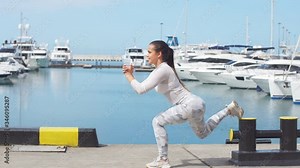 Lunges exercises woman doing front lunge leg exercise workout for quads, thighs and calves strength training. Fitness woman exercising outside on grass.