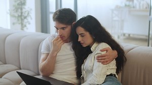 Young couple watching laptop computer at home in slow motion Premium Stock Video Footage