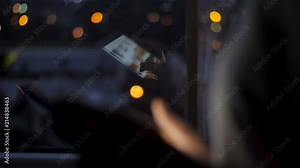 In this close up type of shot you can see young woman holding Apple Ipad touch screen tablet device in her hands. She is scrolling the screen while searching for pictures or reading news feed online.
