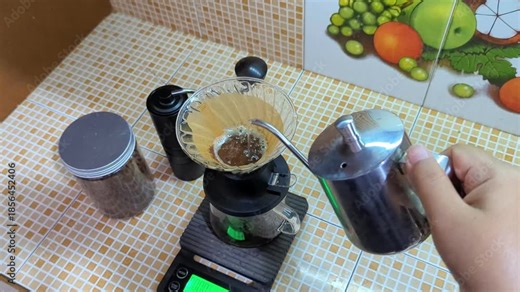 V60 Coffee Blooming Process with Hot Water. Hot water is gently poured into ground coffee in a V60 dripper, creating a blooming effect as gas escapes, Making manual V60 brewing Coffee, 4K Video.