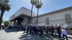 Grocery workers protest in a Food 4 Less store to call on the Kroger Company to pay its workers temporary hazard pay and not close its stores, in Los Angeles, April 8, 2021.
