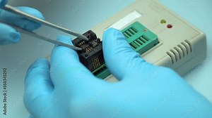 The wizard inserts a chip into the programmer through an adapter, soic8, to program the chip. Technology.