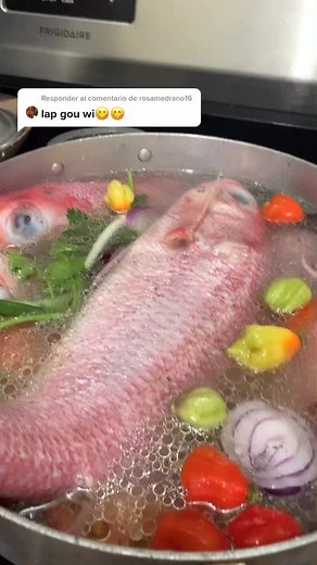 Boiling a Whole Fish with Vegetables in the Kitchen