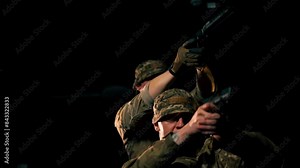 At a professional shooting range two military trainers perform tactical exercises with pistols