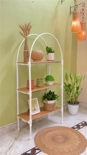 Tanu on Instagram: "DIY-Storage Shelf/Bookshelf Diy details Step 1: 1 started by cutting a half-inch diameter PVC pipe into pieces. Then, I connected them using PVC connectors to form a sturdy frame with three shelves. Step 2: To give the shelf a unique twist, I bent the electric wiring pipe into a round shape and attached it to the top of the frame. Step 3: Next, I spray-painted the entire structure white, giving it a clean and crisp look. Step 4:Meanwhile, I cut wooden planks according to size