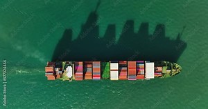 cargo logistic container ship carrying to import export goods and distributing products to dealer and consumers across worldwide by container ship Transportation in open sea.4k video aerial top view