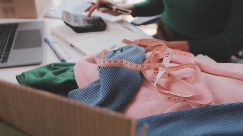 clip-3992476705-asian-beautiful-woman-sell-cloth-product-online