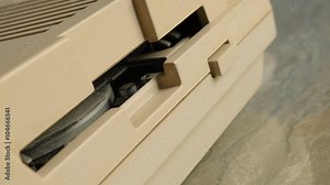 Ejecting diskette and taking from floppy drive close-up 4K 2160p 30fps UltraHD footage - Closeup of ejecting 3.5 inch pink floppy disk from retro computer 4K 3840X2160 UHD video