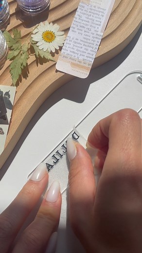 Collage bookmark 🌸 #ad @michaelsstores Steps: 1. Get collage items from @michaelsstores (Vintage paper, glitters, butterflies…) 2. Apply name with vinyl, mirrored 3. Apply thin coat of Mod Podge and apply flowers 4. Keep applying Mod Podge and other collage elements 5. Seal all together with last coat of Mod Podge 6. Dry it completely, add tassels ❤️ (Bookmark blanks are available on our website💫) #makeitwithmichaels #cricut #cricutmade #cricutcrafts #diybookmark #collageart #cricutproject #ba