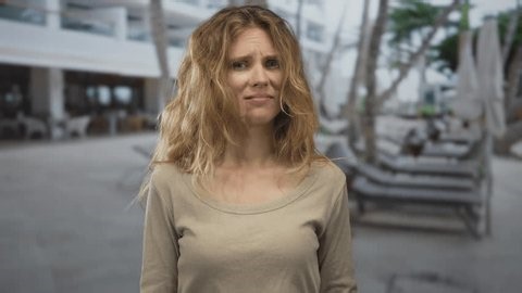 clip-3995536831-woman-lifts-hands-refuse-check-pool-resort