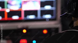 Close-Up of Broadcast Technician with Headset in TV Control Room During Live Production