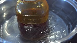 Marijuana Extract In A Jar Placed In Boiling Water For Mass Distribution - close up