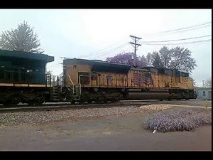 UP 8657 leads CSX ES44AH on long 260 car EB mixed freight with mid-train DPU