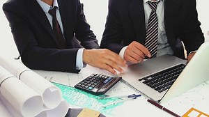 Engineers in suits working in front of a computer - Free Stock Video