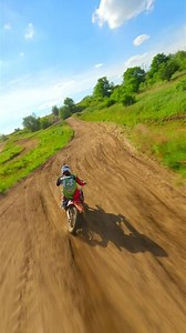 FPV drone chasing rider on a motocross track in slow motion.
