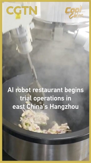 A fully robotic restaurant where AI-powered robots prepare and serve a full range of dishes, drinks and desserts has started trial operations in Hangzhou City, east China's Zhejiang Province. More than 10 robots are currently in operation at the restaurant, including cooking, noodle-making, coffee-making and floor-cleaning robots, covering multiple stages such as food preparation, serving and cleaning. | CGTN
