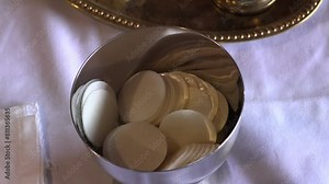 Communion. Moment of the consecration of the cup with wafers on an altar in the Catholic Church. Religious symbols of the body and blood of Christ. Roman Catholic Apostolic Mass. Eucharist.