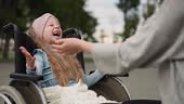 Toothless girl laughs while playing fun game with mother in spring...