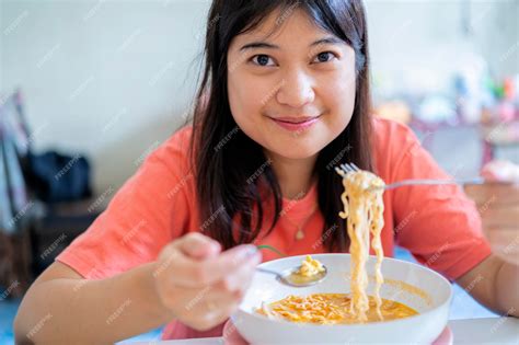 Premium Photo Asian Woman Eating Instant Noodles Is Happy To Eat She Sat At The Dining Table