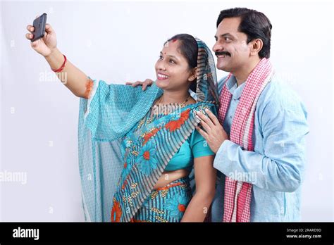 Rural Indian Village Couple Happily Taking A Selfie From A Mobile Phone Woman Wearing Saree And