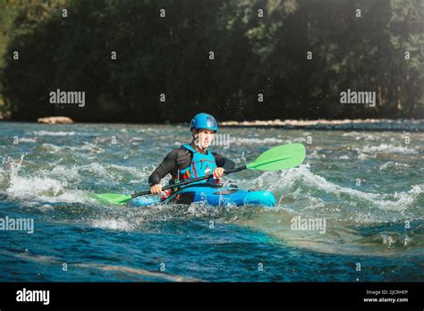 Male Recreational Athlete Paddling Carefully Over The Risky Foamy And Splashy Whitewater
