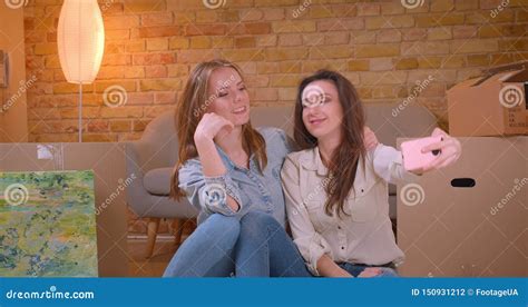 Closeup Shoot Of Young Beautiful Lesbian Couple Taking Selfies On The Phone Kissing Happily And