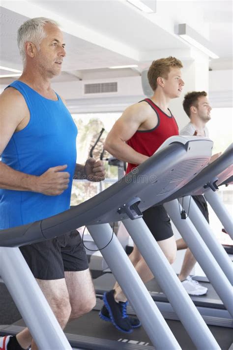 Group Of Men Using Running Machines In Gym Stock Image Image Of
